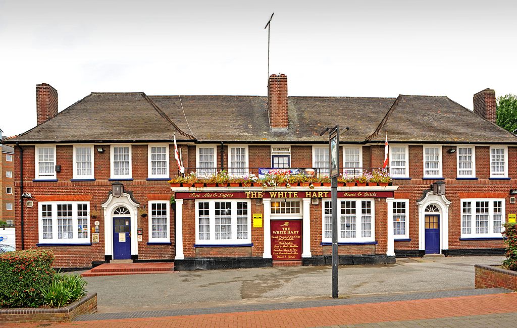 Inside the White Hart there is an impressive oak bar which stretches ...